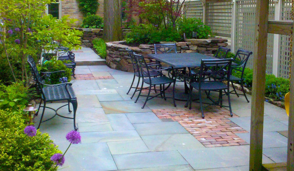 Bluestone terrace with street paver insets and field stone wall ...