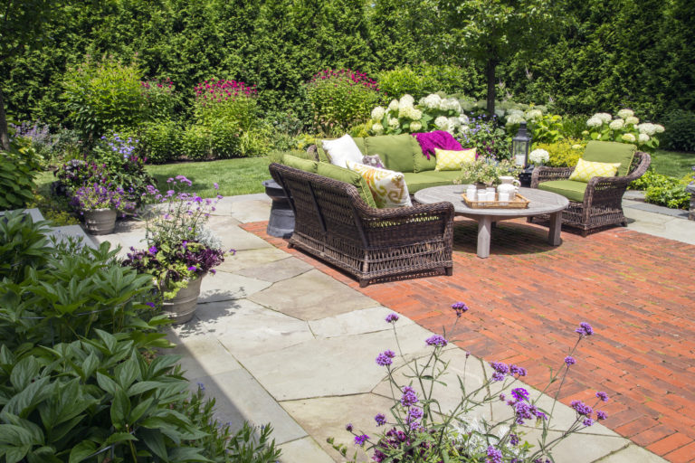 Irregular flagstone patio with a clay paver inset - Hirsch Brick and Stone